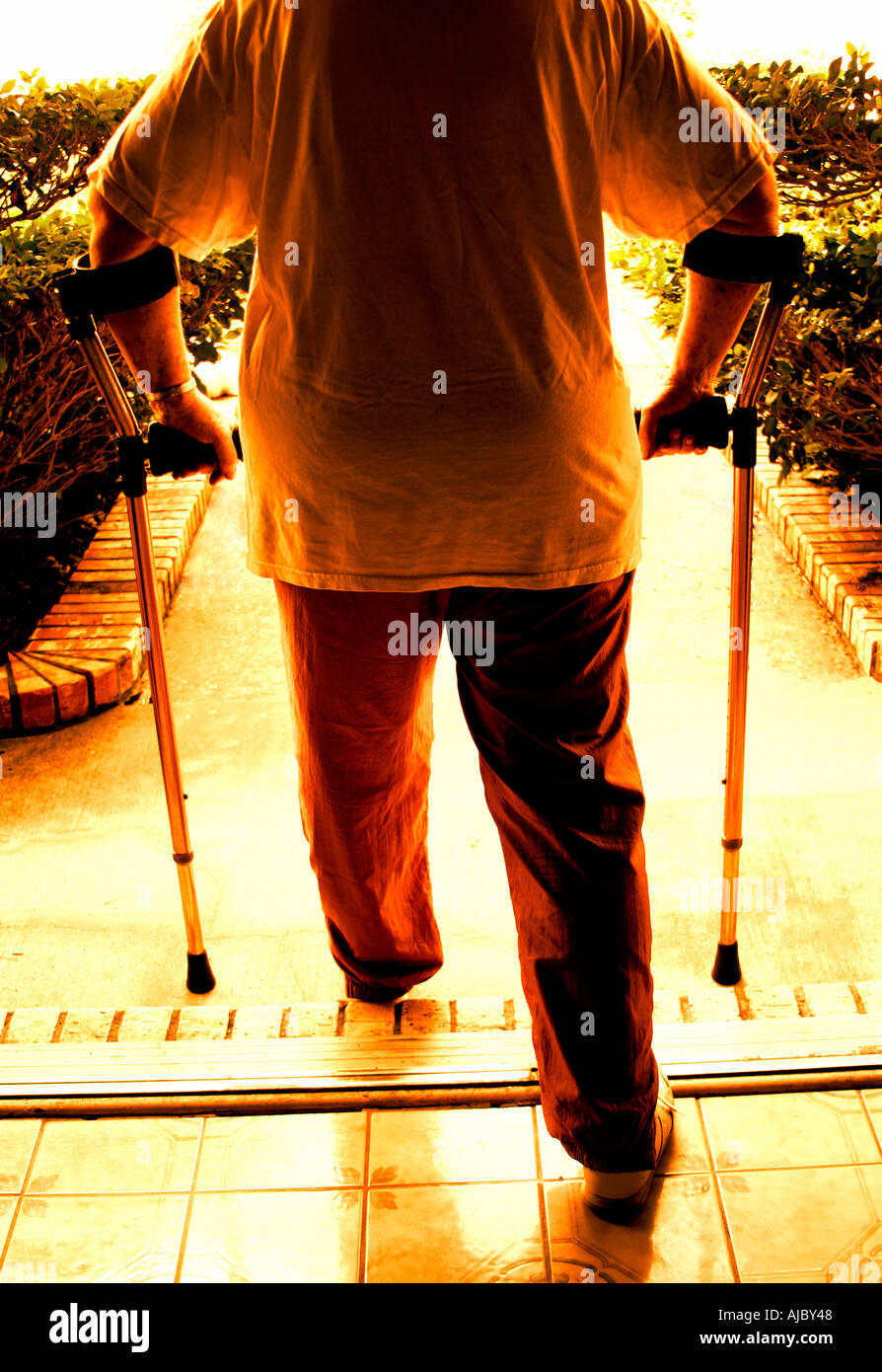 Adult with Handicap Walking With Crutches Disabilities Stock Photo - Alamy