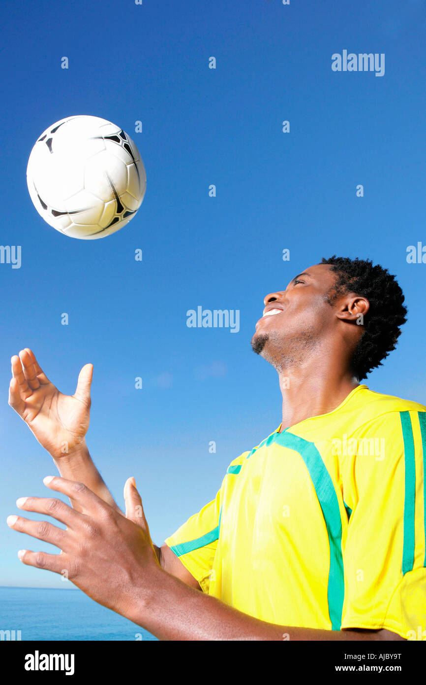 African Man Playing with a Soccer Ball - Low Angle View Stock Photo - Alamy