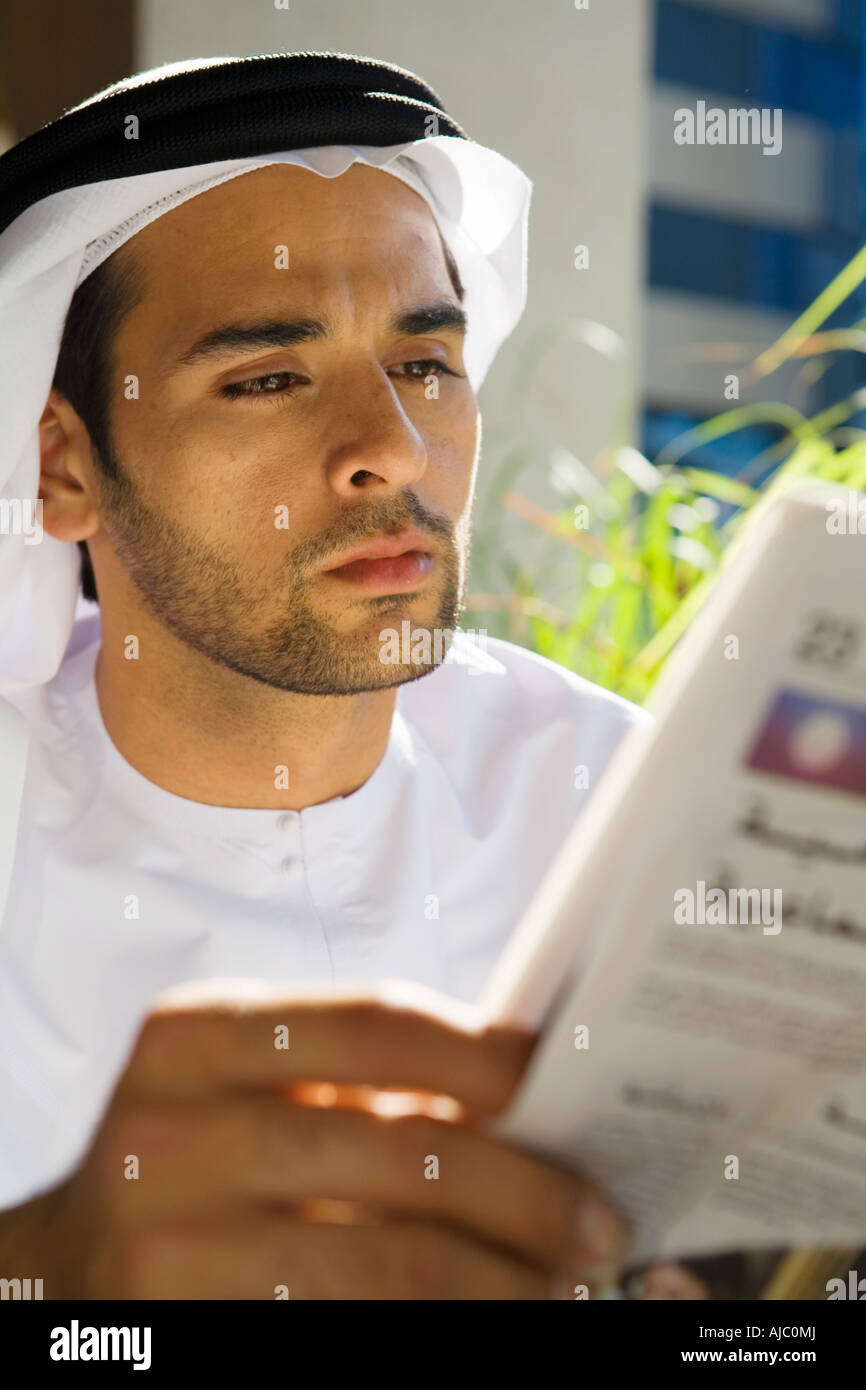 Arab Man Reading Newspaper in Café Stock Photo - Alamy