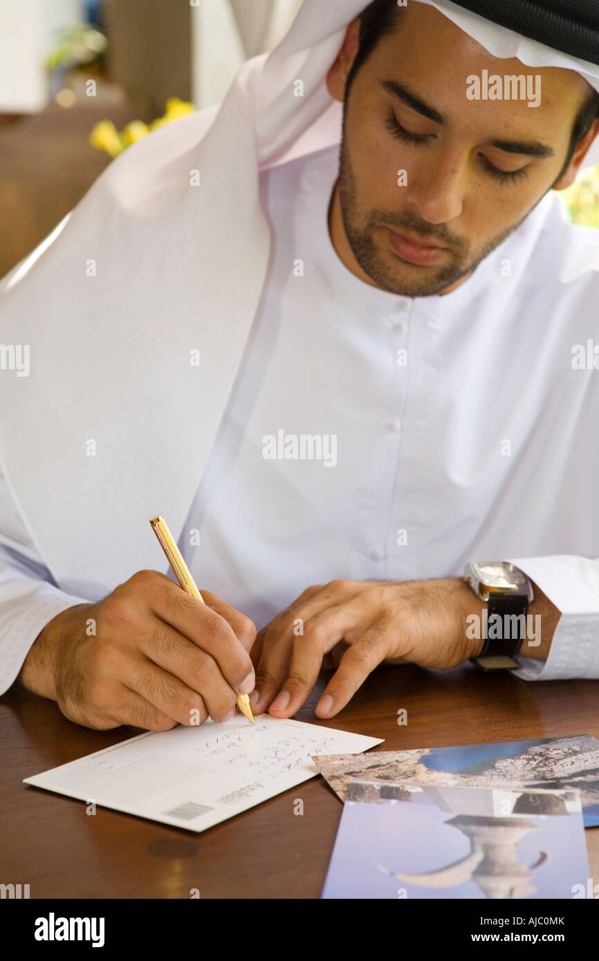Arab Man Writing Postcards on Table Stock Photo - Alamy