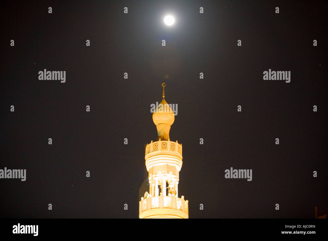 Minaret of Mosque Symmetrical with the Moon at Night Stock Photo - Alamy