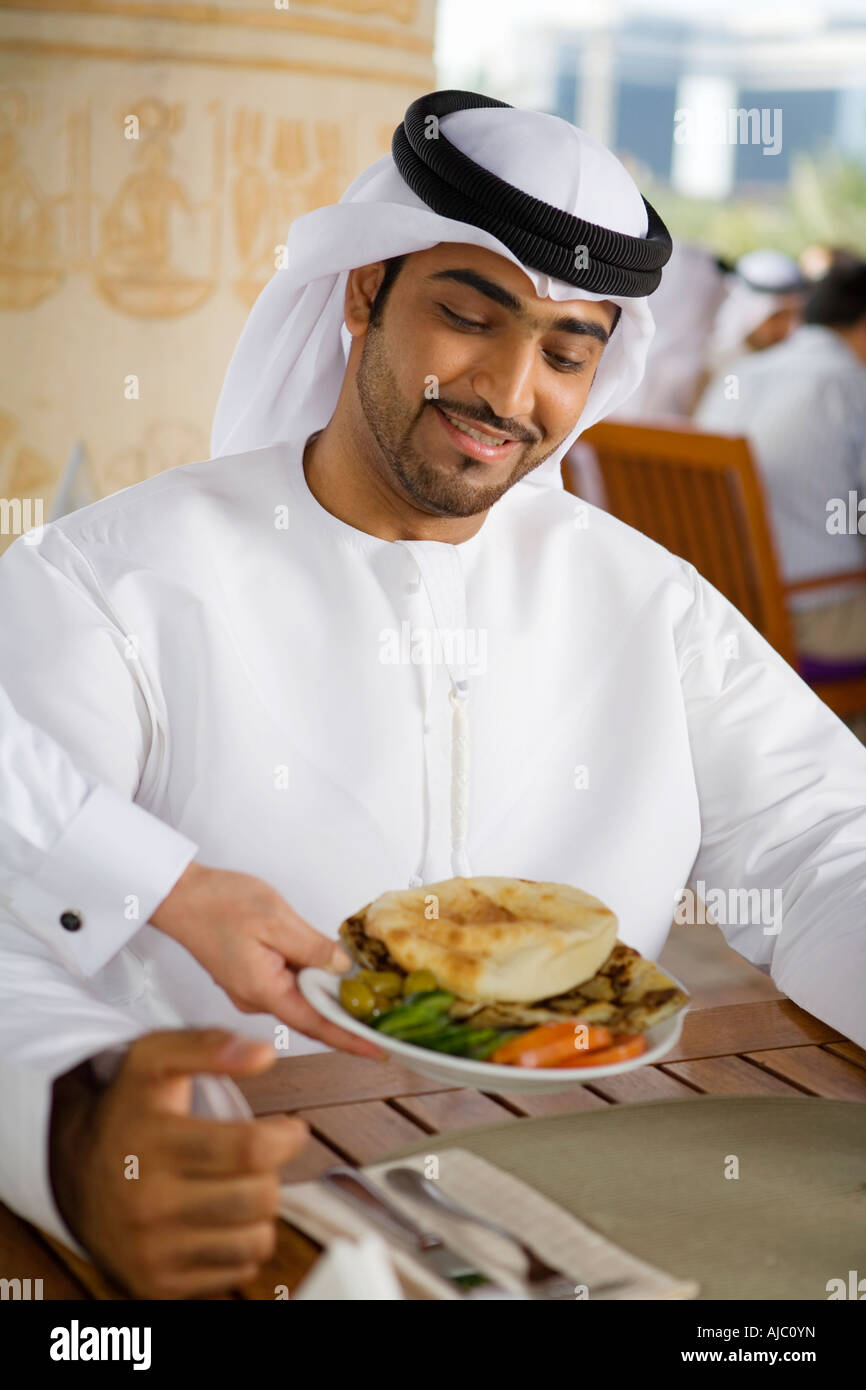 Waitress Serving Smiling Arab Man Lunch in Café Stock Photo - Alamy