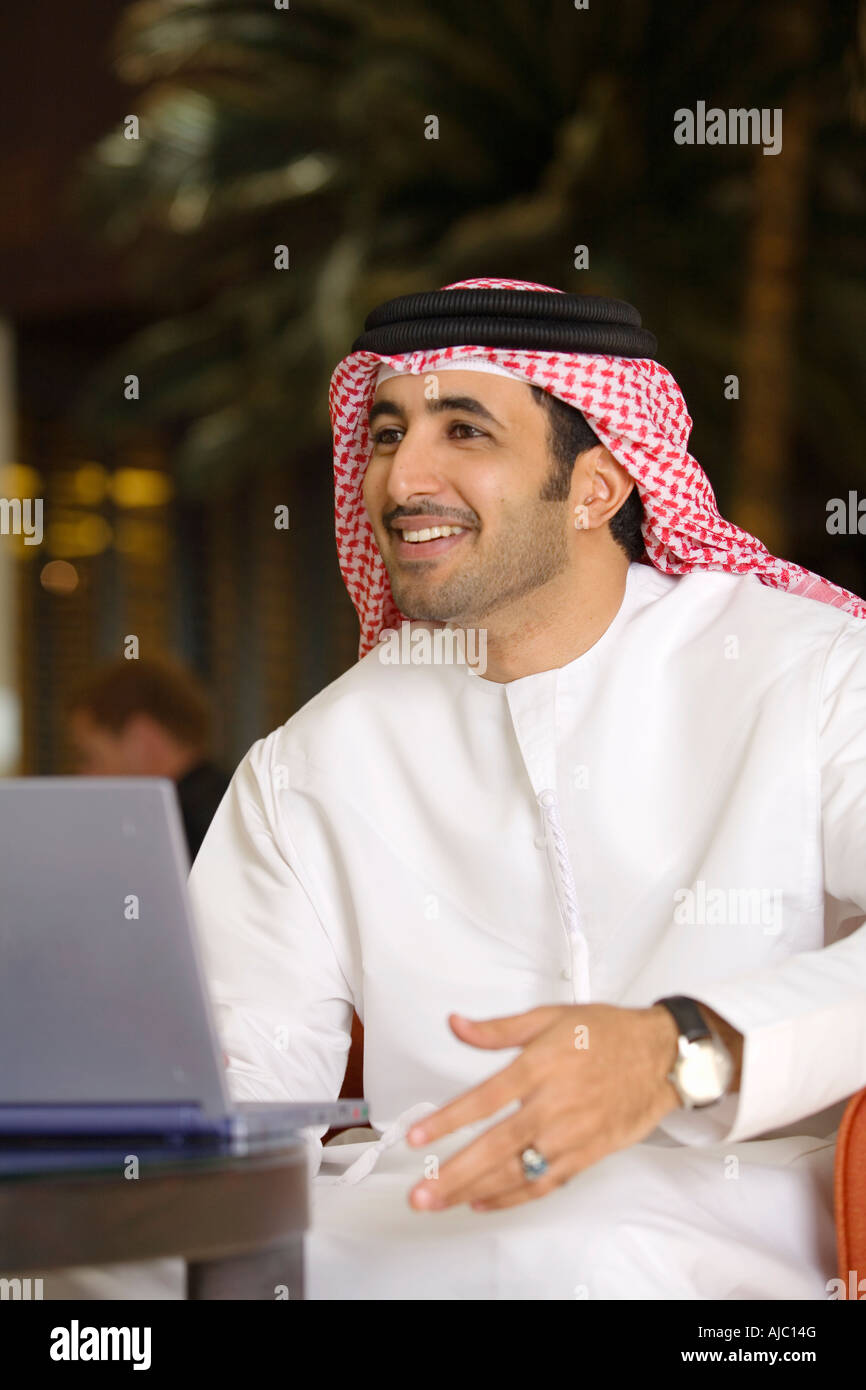 Arab Man Gesturing to Friend in Front of Laptop Computer Stock Photo ...