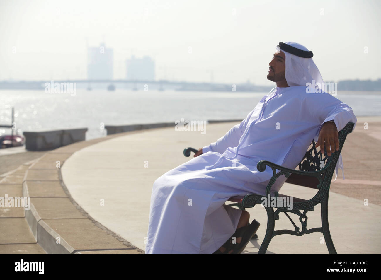 Arab Man Sitting on Park Bench Stock Photo - Alamy