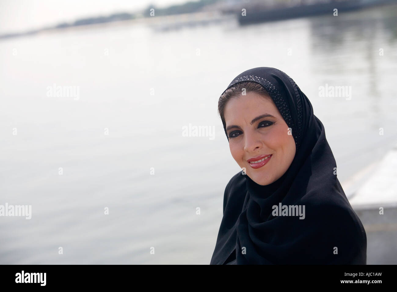 Smiling arab woman sitting hi-res stock photography and images - Alamy
