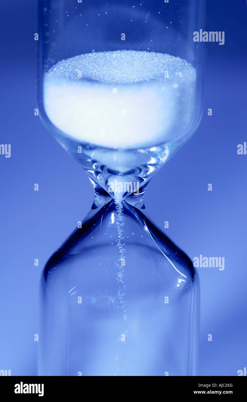 Sand Falling Through an Hourglass Stock Photo - Alamy