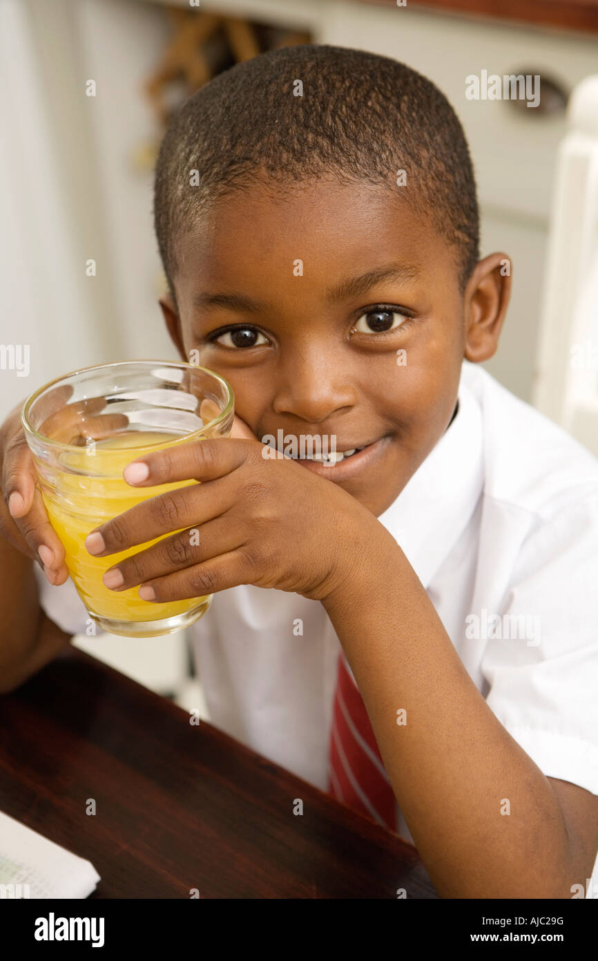 Young African Boy Drinking a Glass of Fruit Juice Stock Photo - Alamy
