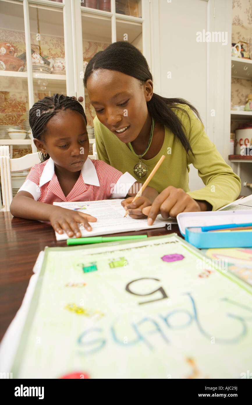 African Woman Helping her Daughter with School Homework Stock Photo - Alamy