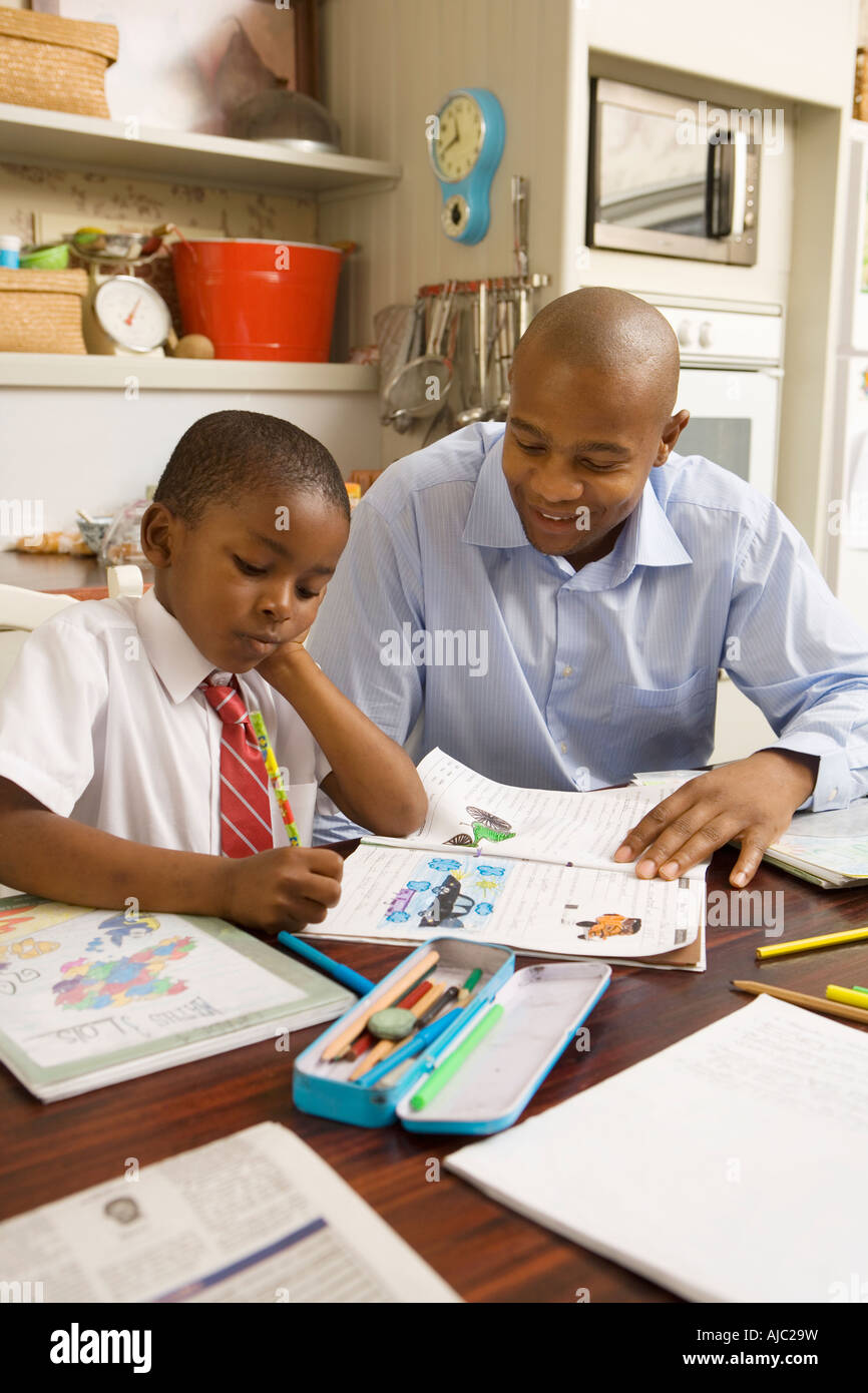 African Man Helping his Son with his Homework Stock Photo - Alamy