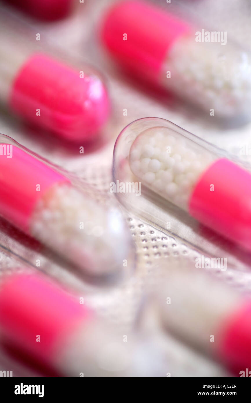 Extreme Close-up of a Sheet of Pink Pill Capsules Stock Photo - Alamy