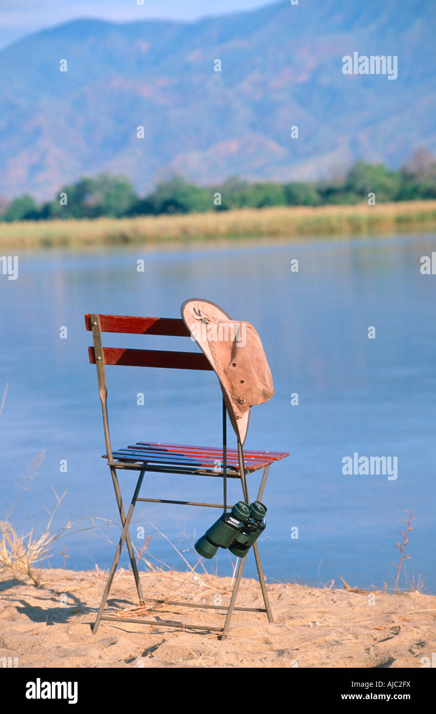 Chair, Hat and Binoculars on a Riverbank Stock Photo - Alamy