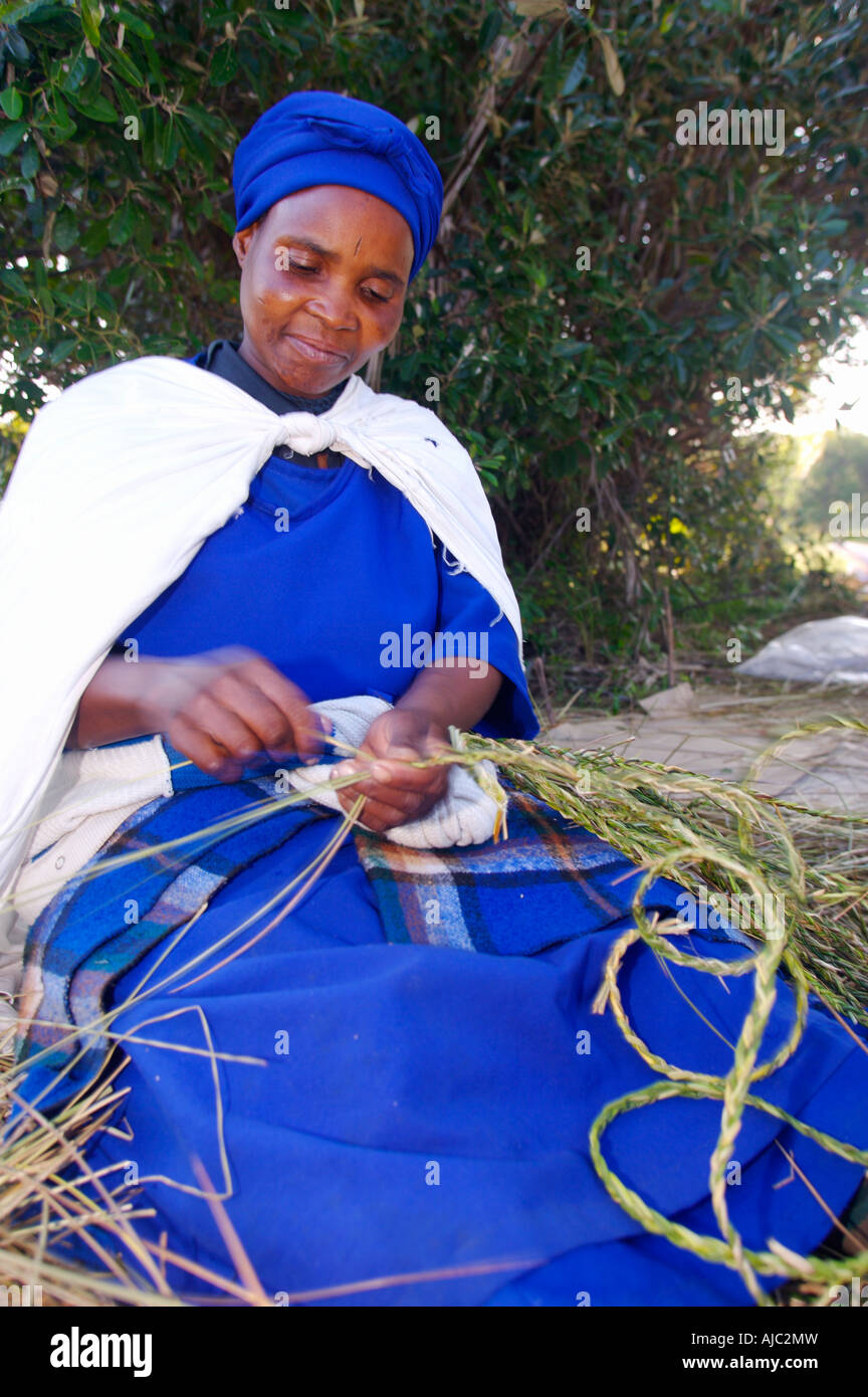 African Woman Rolling Reeds Stock Photo - Alamy