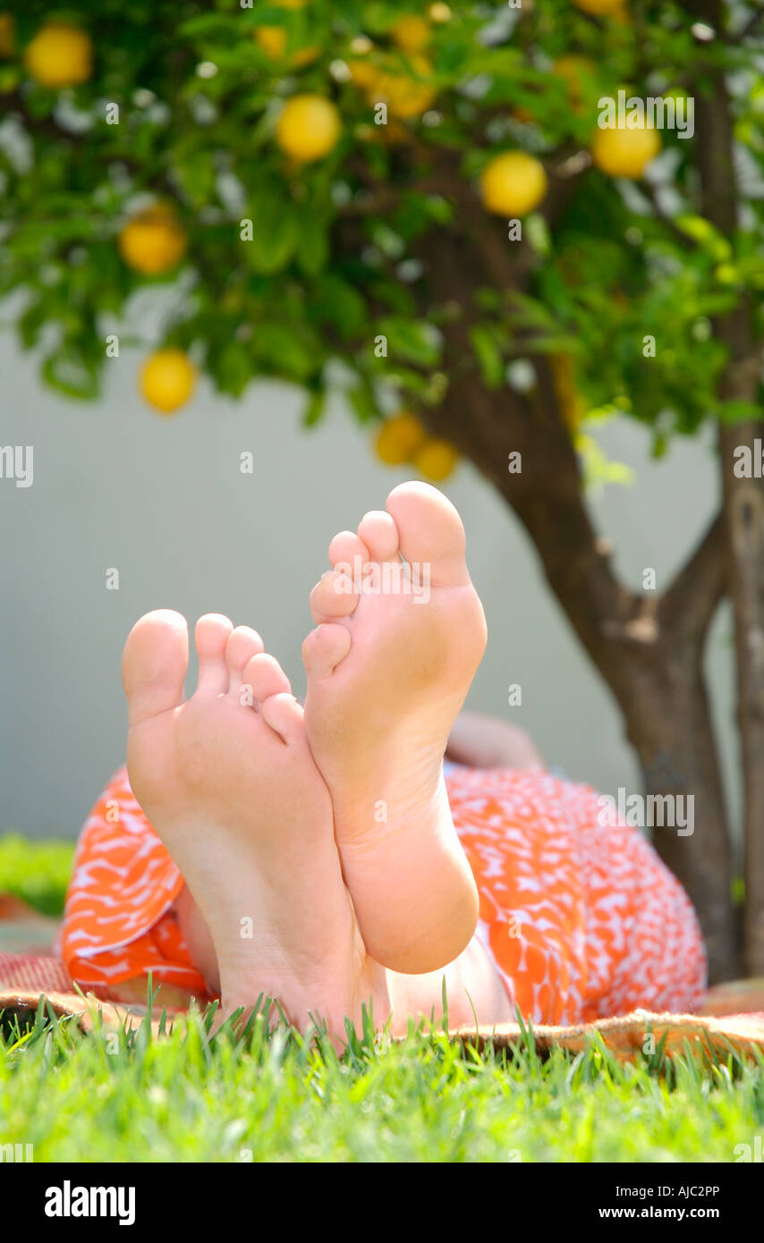 Woman sleeping under tree hi-res stock photography and images - Alamy