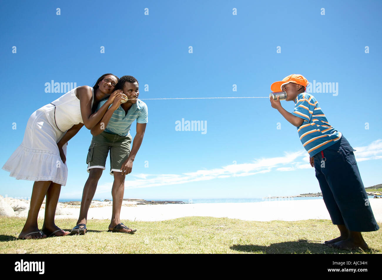 African Family Talking on a String Telephone Stock Photo - Alamy