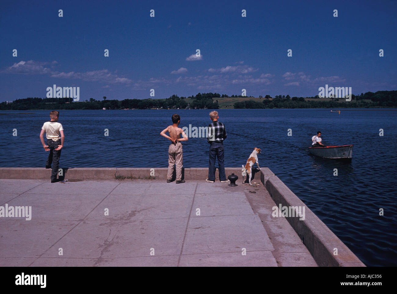 Boys looking over lake 1950 Stock Photo - Alamy