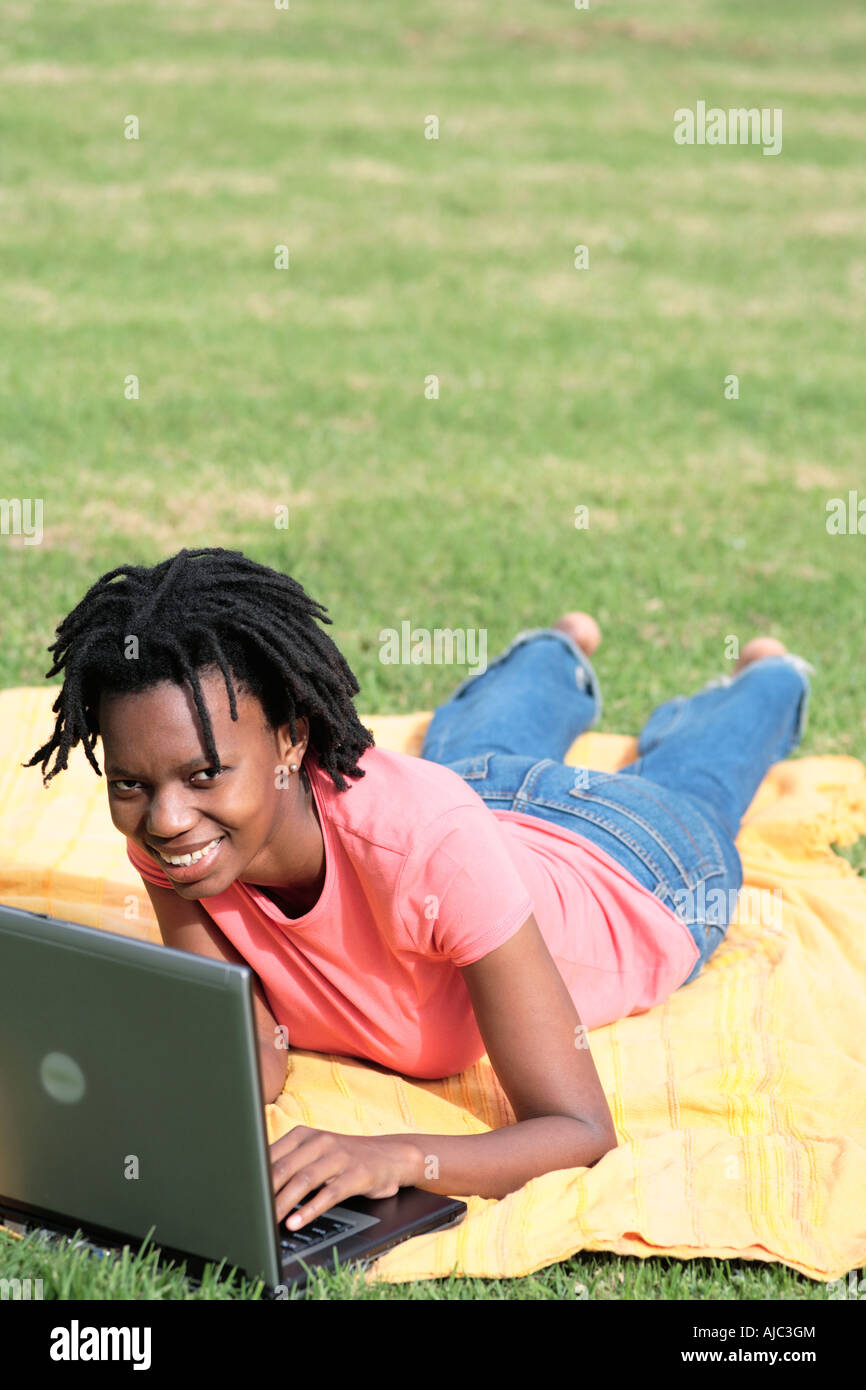 Young Woman Lying down Working on her Laptop Stock Photo - Alamy