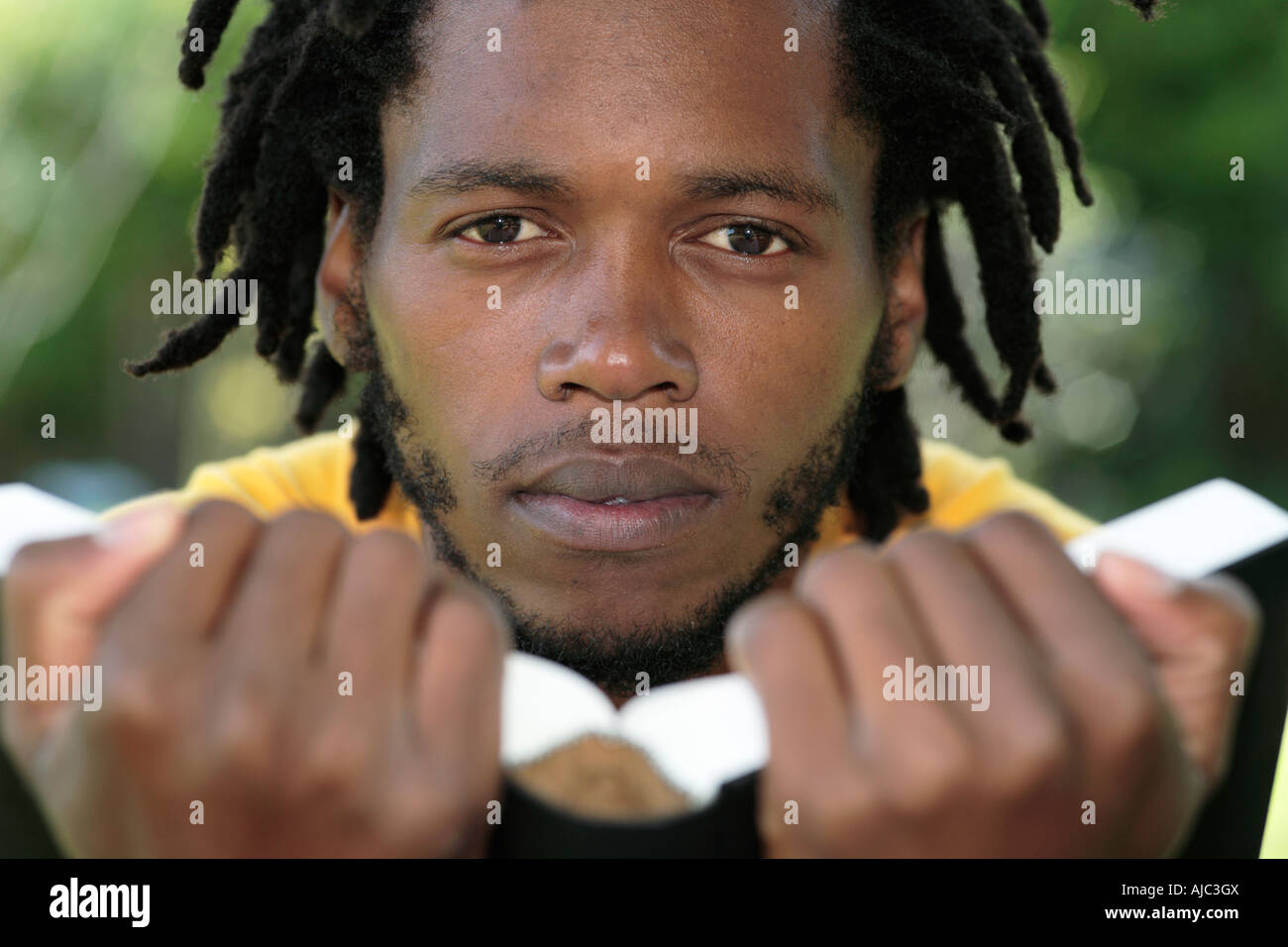 Young Man Looking up over the Top of a Book Stock Photo - Alamy