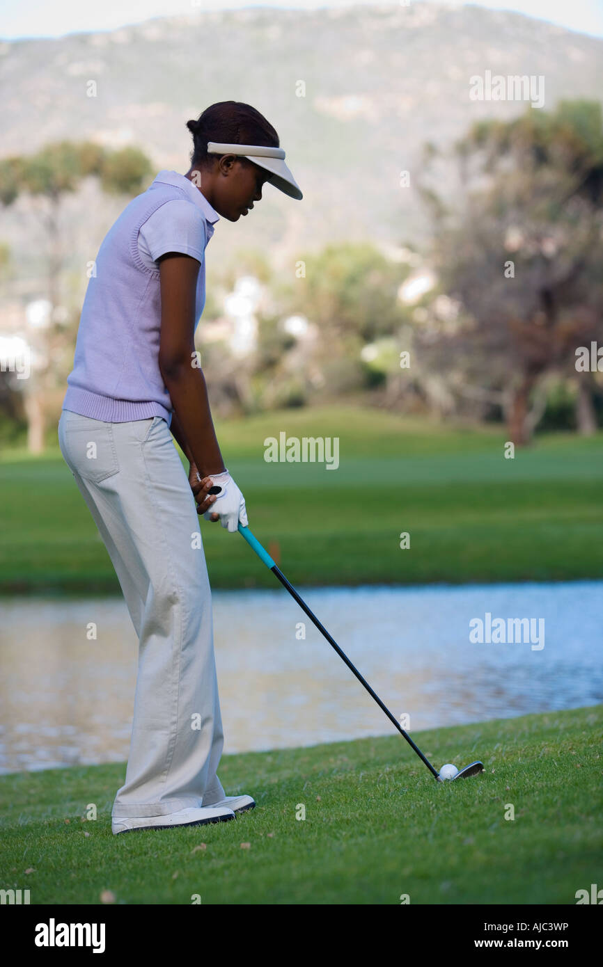 Side View of Woman Addressing Golf Ball Stock Photo - Alamy