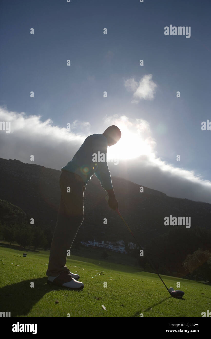 Man Addressing Golf Ball on Tee Box Stock Photo - Alamy
