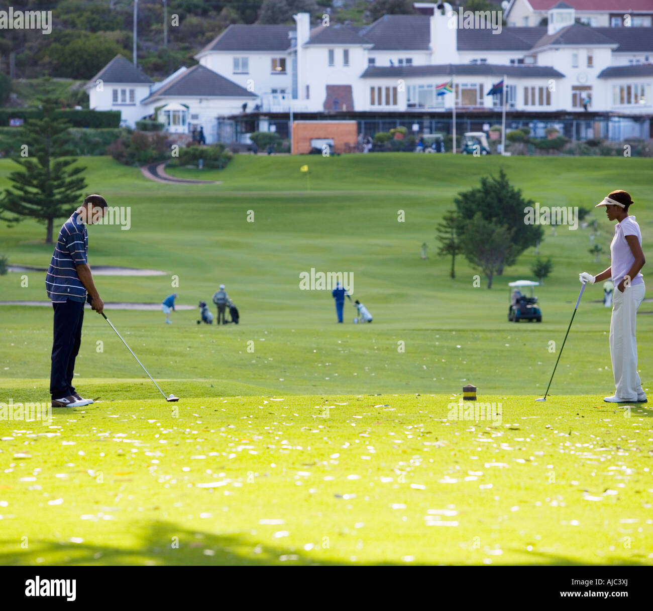 Man Addressing Golf Ball on Tee Box Stock Photo - Alamy