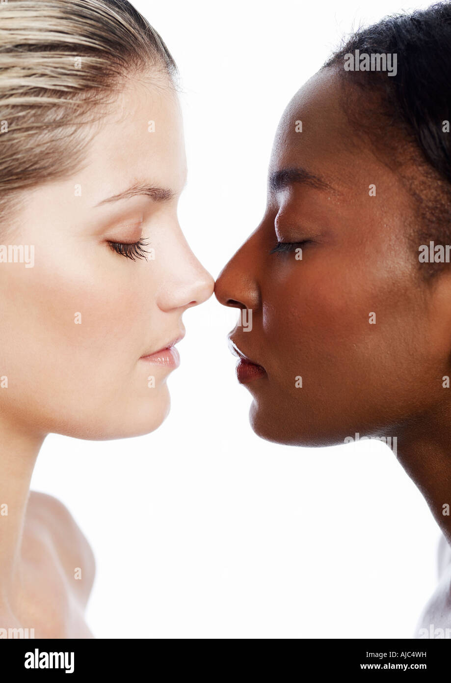 African and Caucasian Woman Nose to Nose Stock Photo - Alamy
