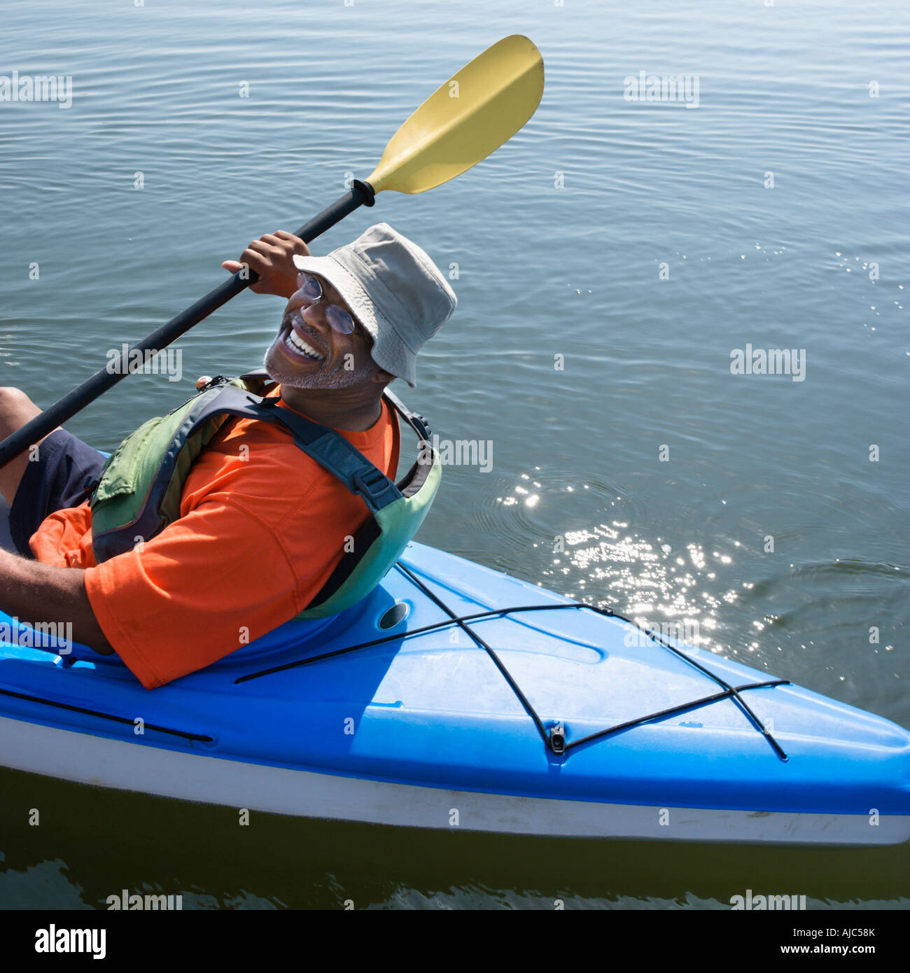 African American middle aged man smiling at viewer in kayak Stock Photo ...