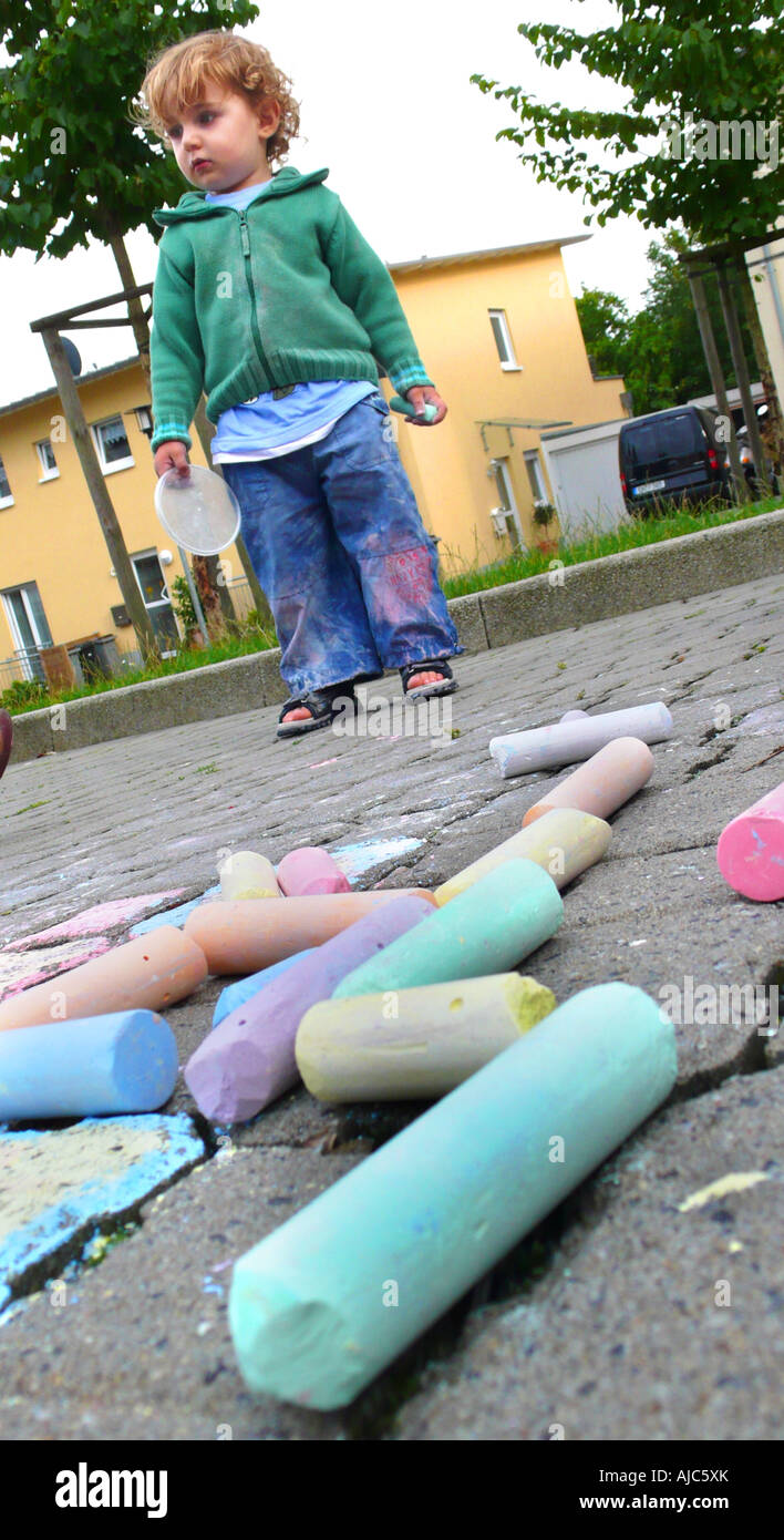 little boy playing with crayon Stock Photo - Alamy