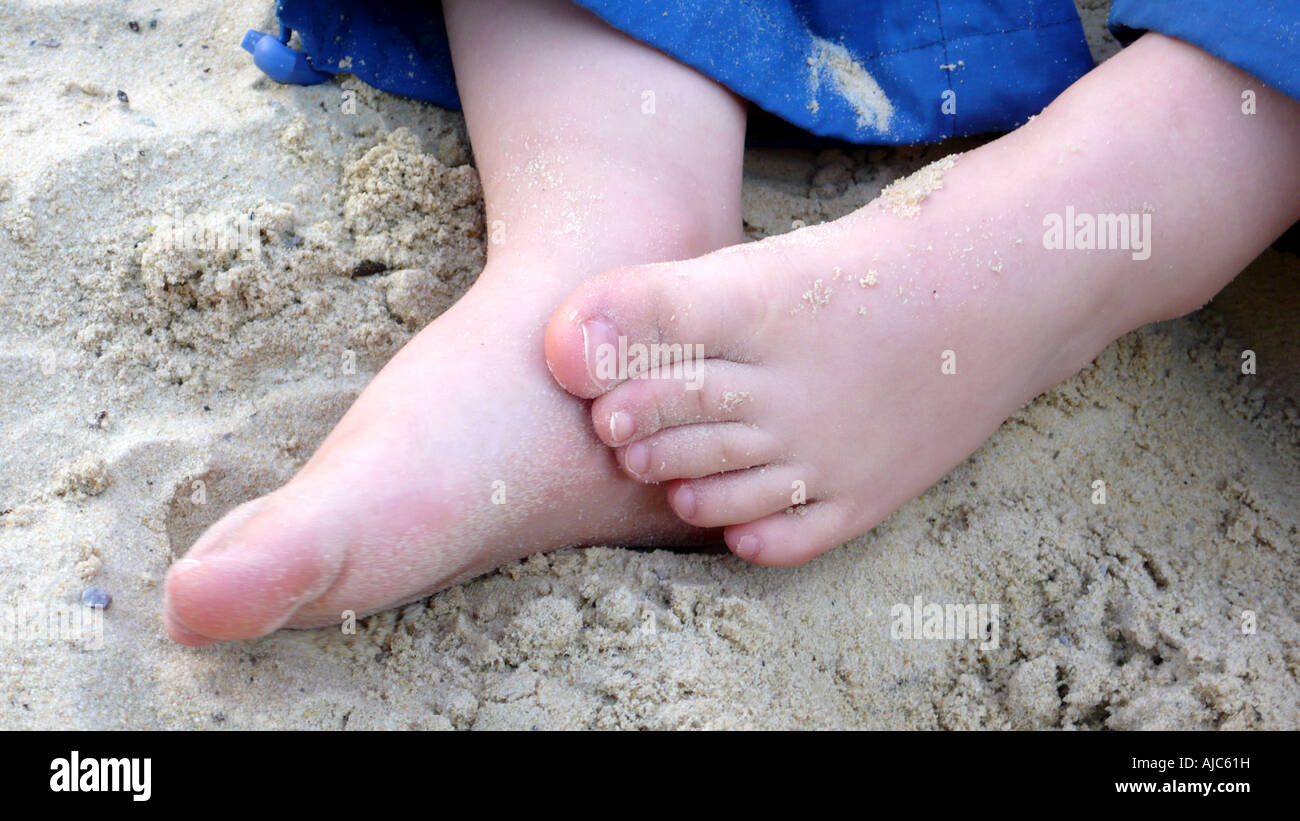 feet of y little child in sand Stock Photo - Alamy