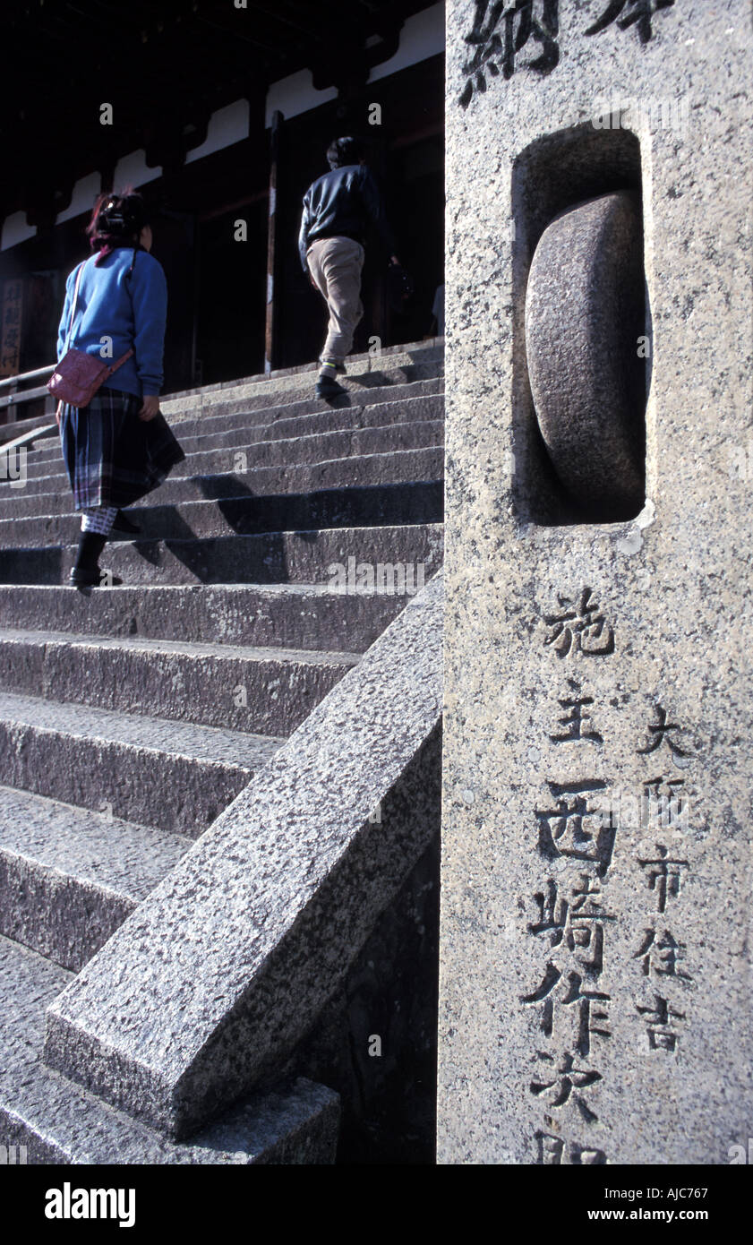 Steps and stone prayer wheel at the foot of a Buddhist temple Taima ...