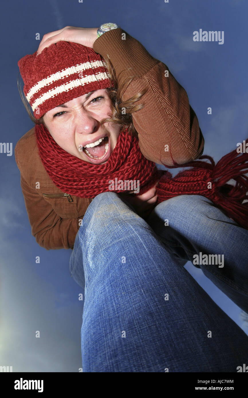 crying young crazy woman wearing cap and scarf Stock Photo - Alamy