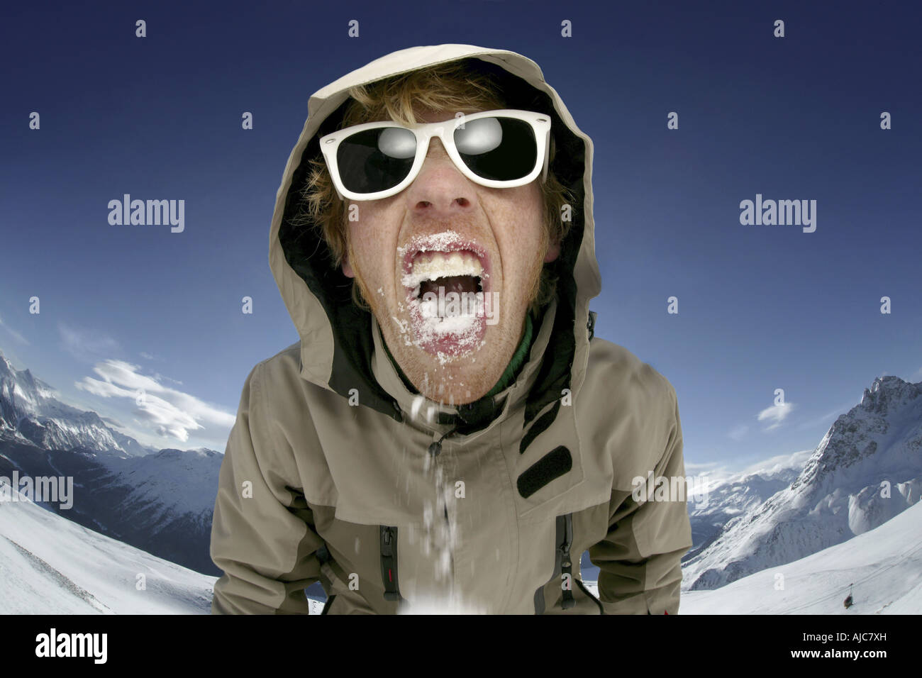 young man with sunglasses eating snow Stock Photo - Alamy