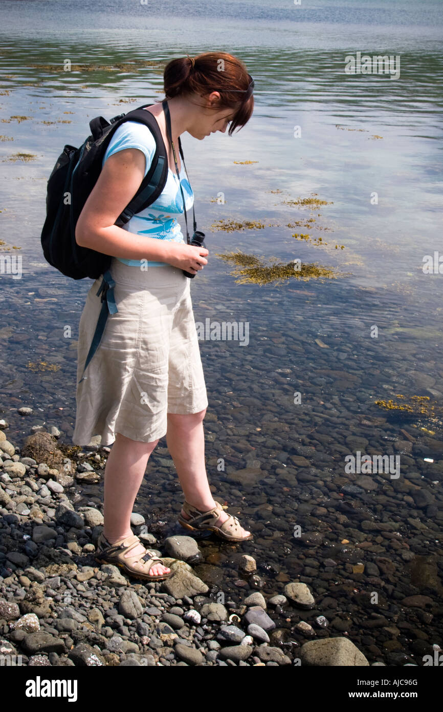 Woman dips her toe into the cold water Stock Photo - Alamy