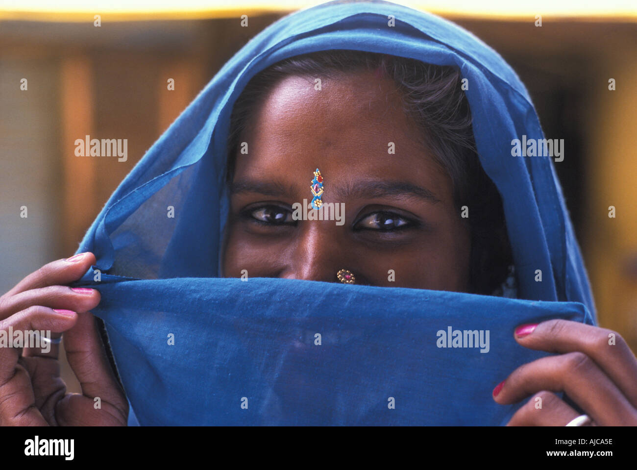 Friendly Hindu woman from Uttar Pradesh with blue headcloth veiling her ...