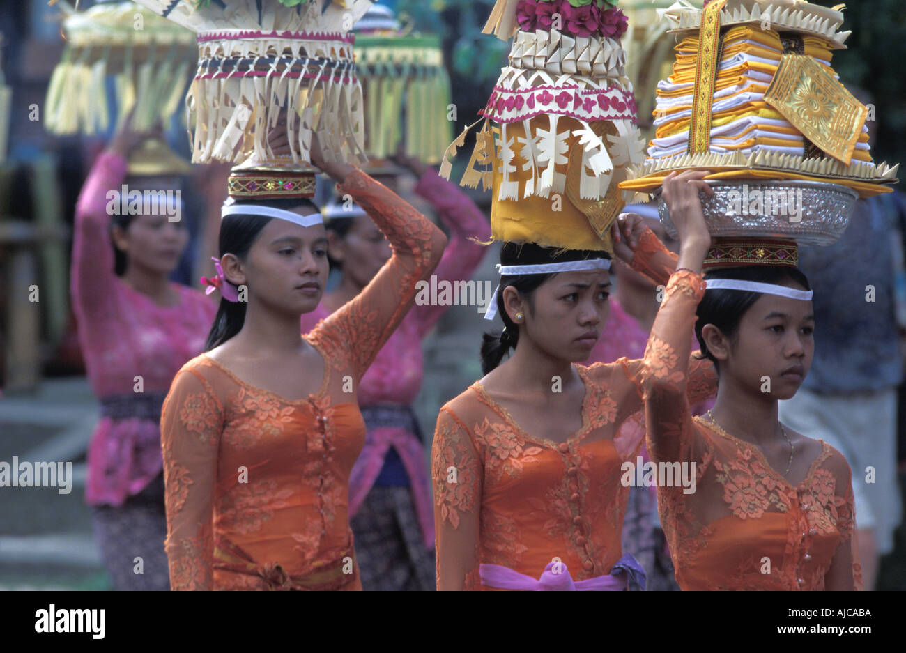 A group of brightly dressed Balinese women in a procession Full moon ...