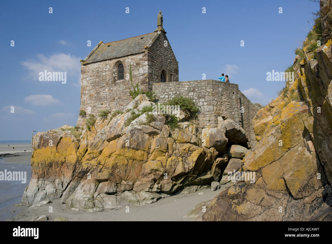Small stone church on rock outcrop behind Mont Saint Michel Brittany ...