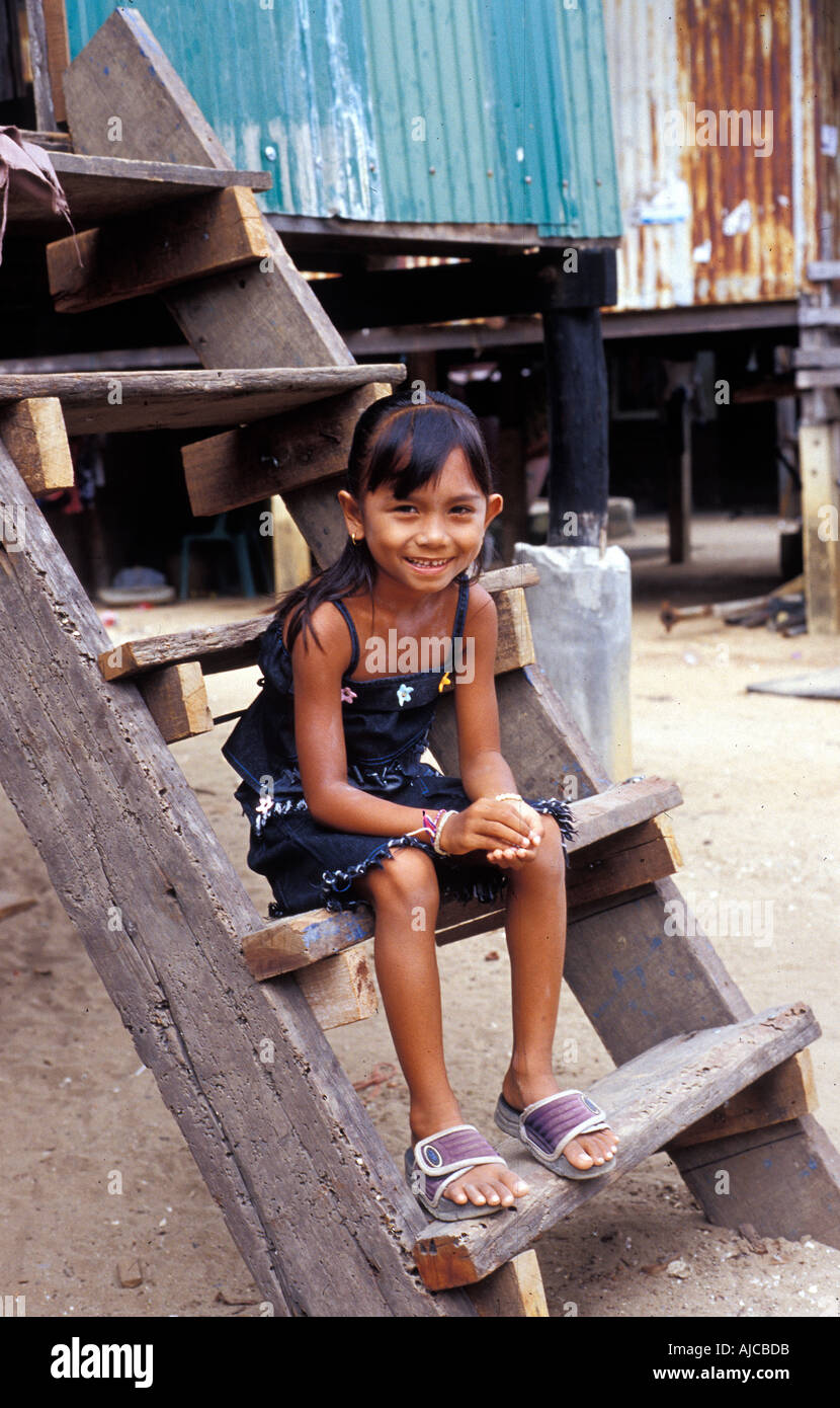 Thai Girl Seated For A Photograph At The Foot Of The Steps To Her