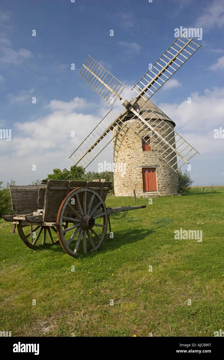 Restored French windmill with old cart in foreground near Cherrueiux ...