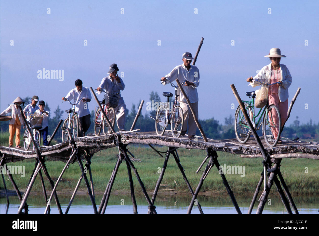 Crossing the bamboo footbridge that spans the Thu Bon River Hoi An ...