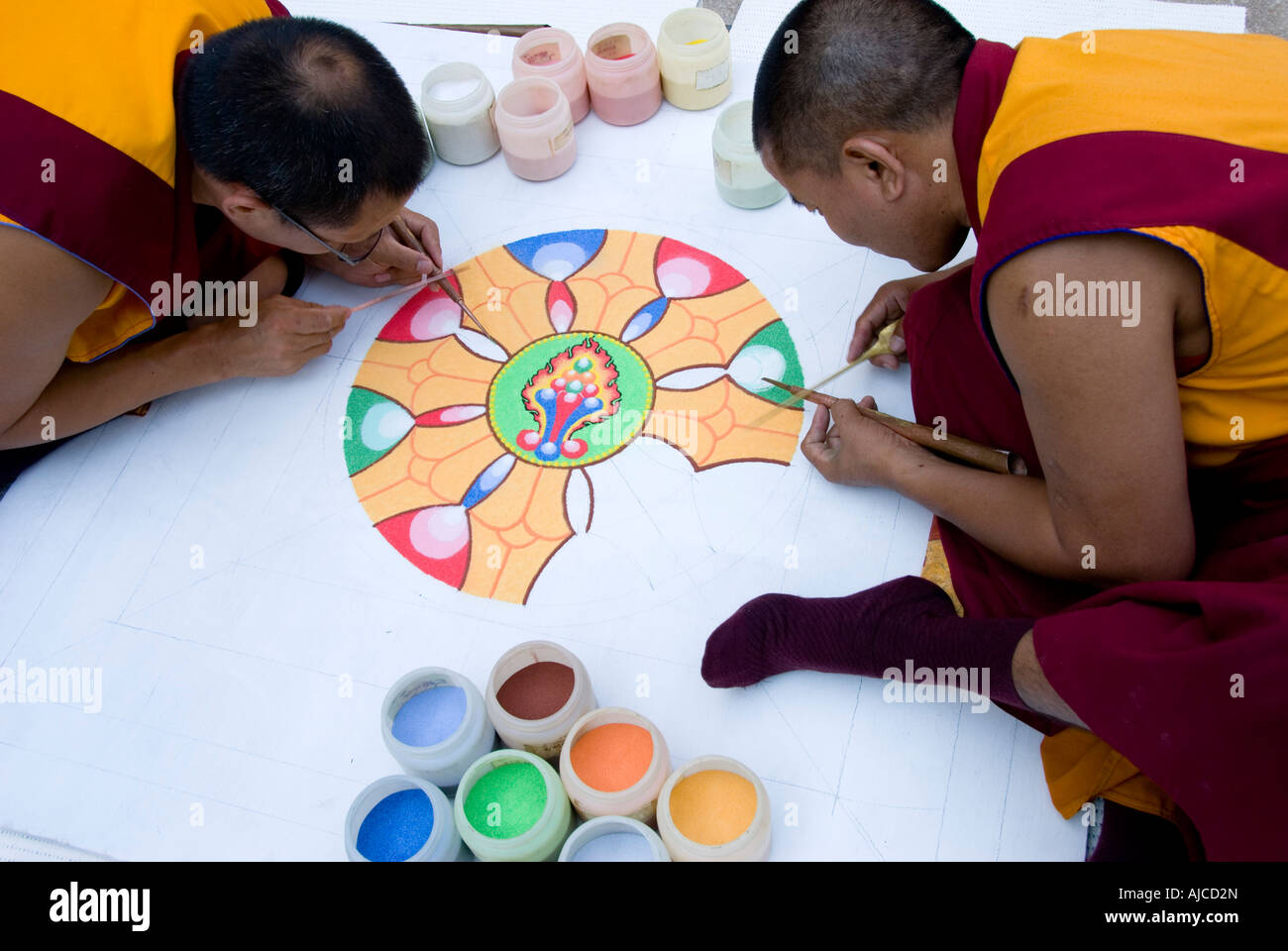 Tibetan monks working on sand mandala Stock Photo - Alamy