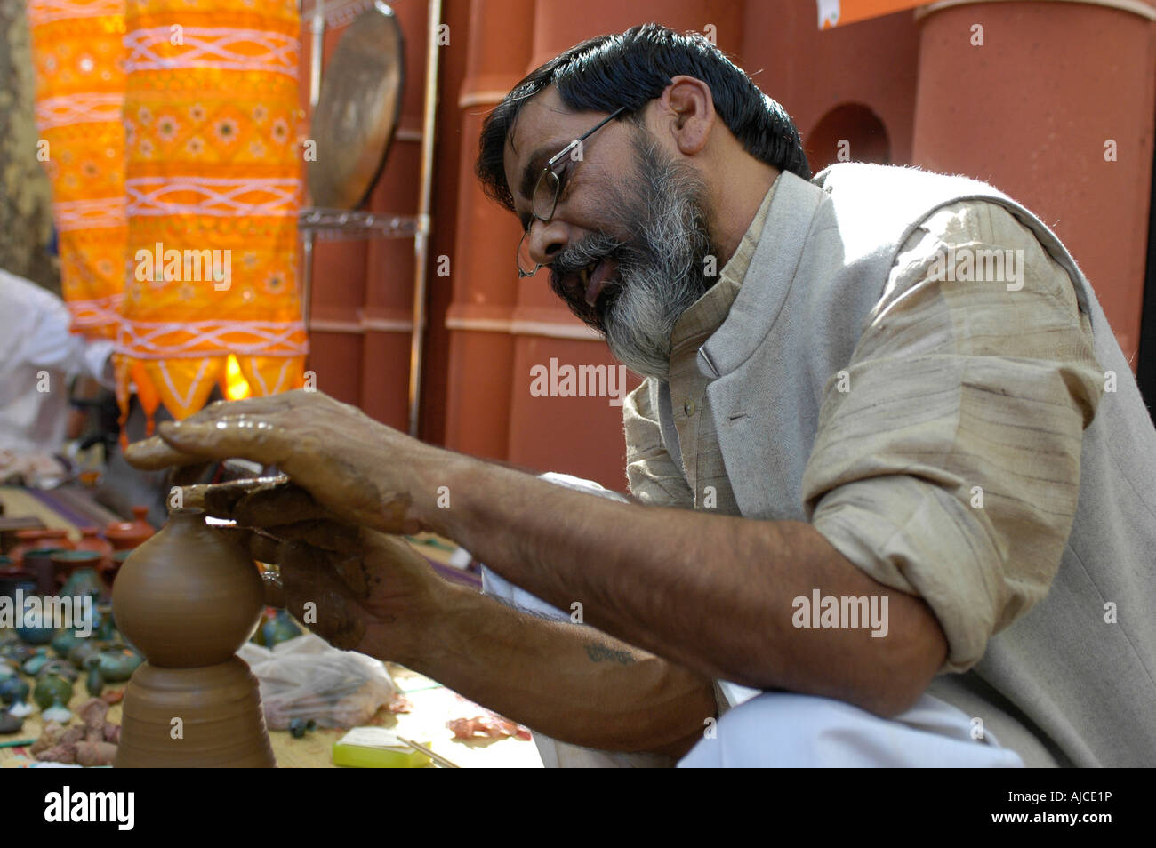 Master potter Shri Har Kishan from India demonstrates throwing a pot in ...