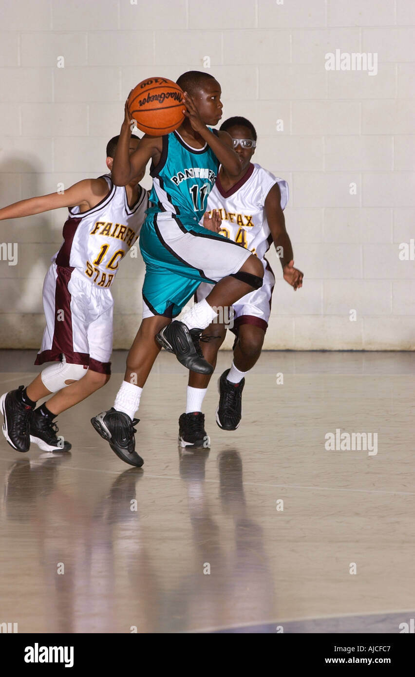 Boys basketball game action Stock Photo - Alamy