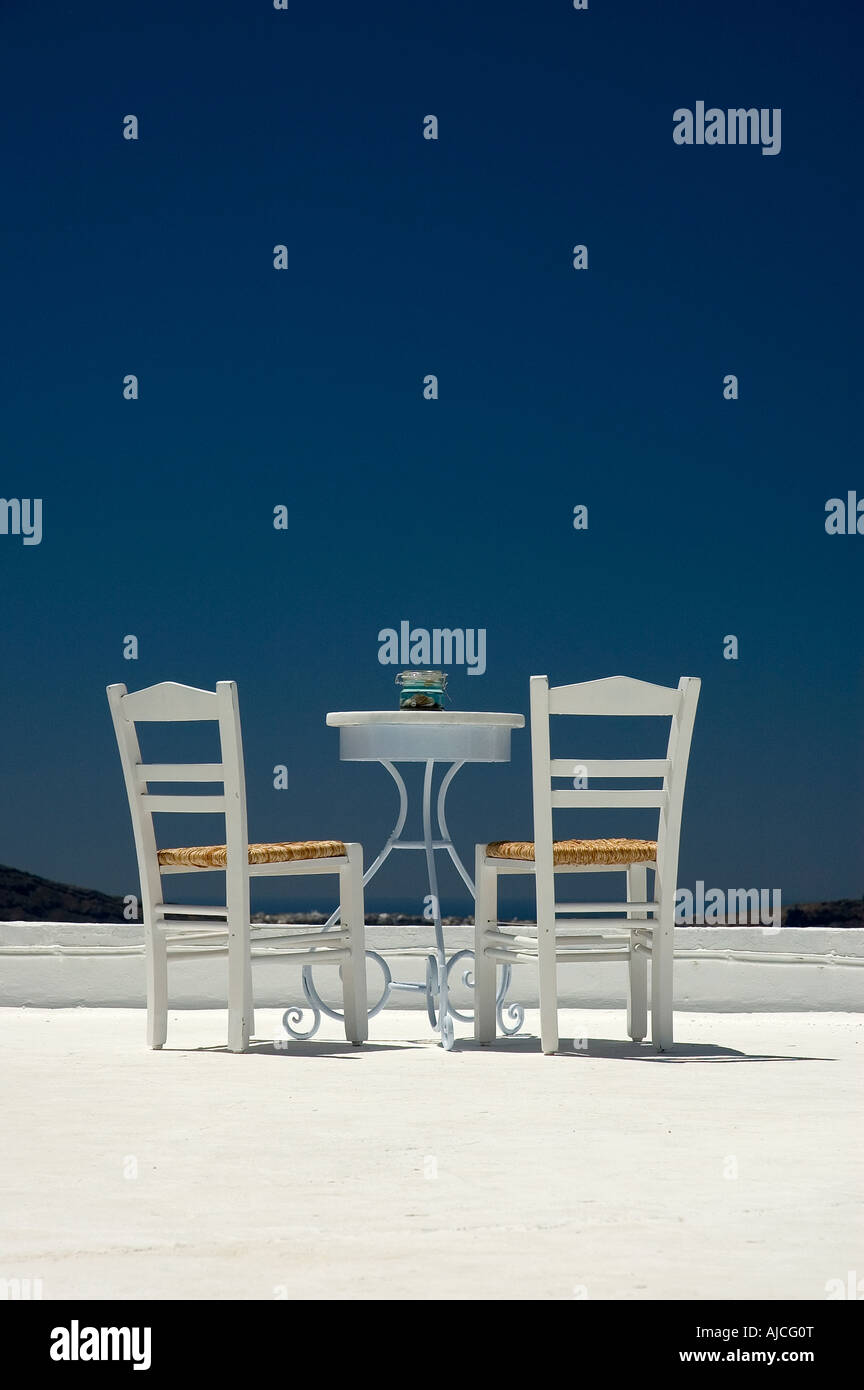 table and chairs with single blue jar overlooking the Mediterranean ...