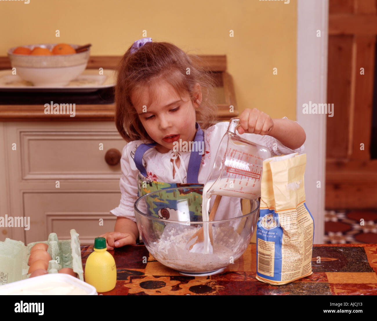 Child Baking a Cake in the Kitchen at Home Stock Photo - Alamy