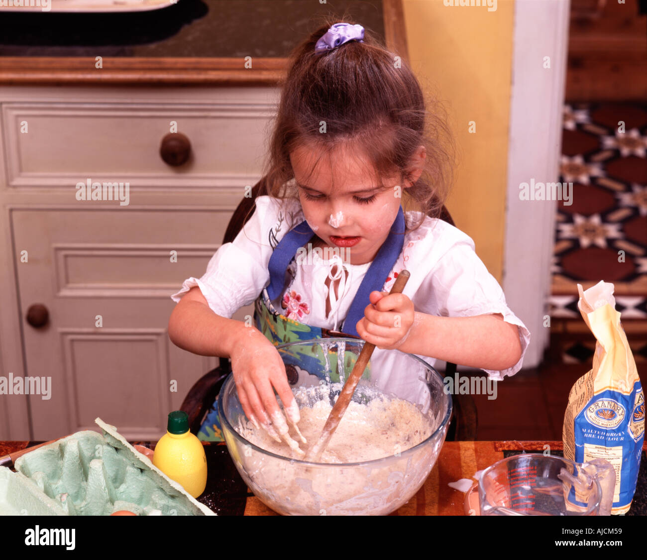 Child Baking a Cake in the Kitchen at Home Stock Photo - Alamy
