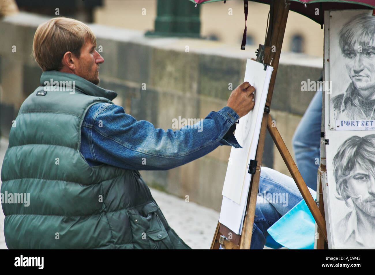 Artist sketching portraits on the Charles Bridge in Prague Czech ...
