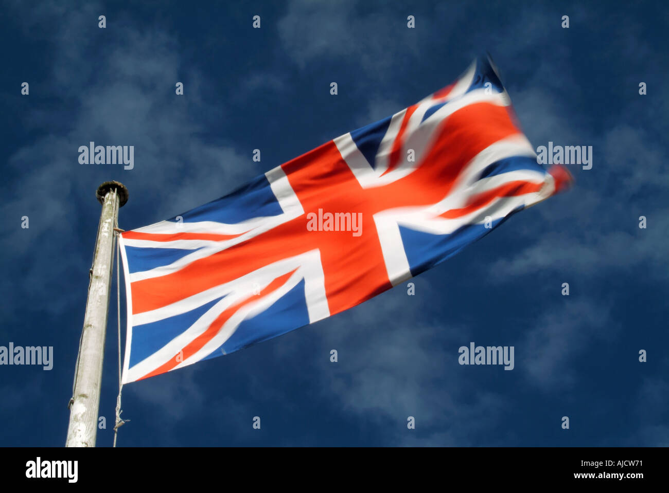 Union flag at full stretch on pole in strong wind fast shutter speed ...