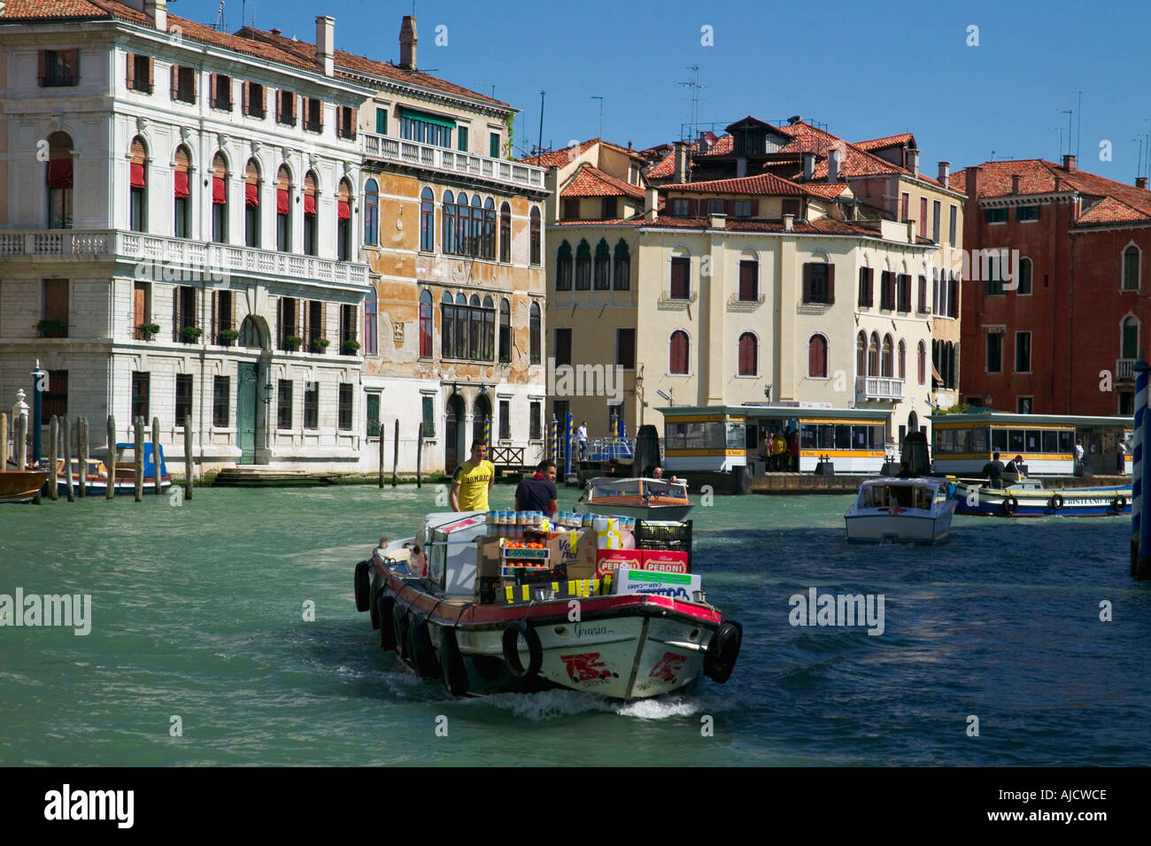 Delivery boat making its way along the Grand Canal to the marketplace ...