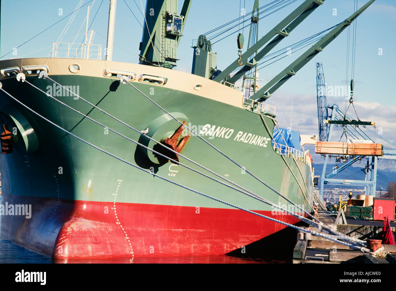 Loading lumber onto freighter Stock Photo - Alamy