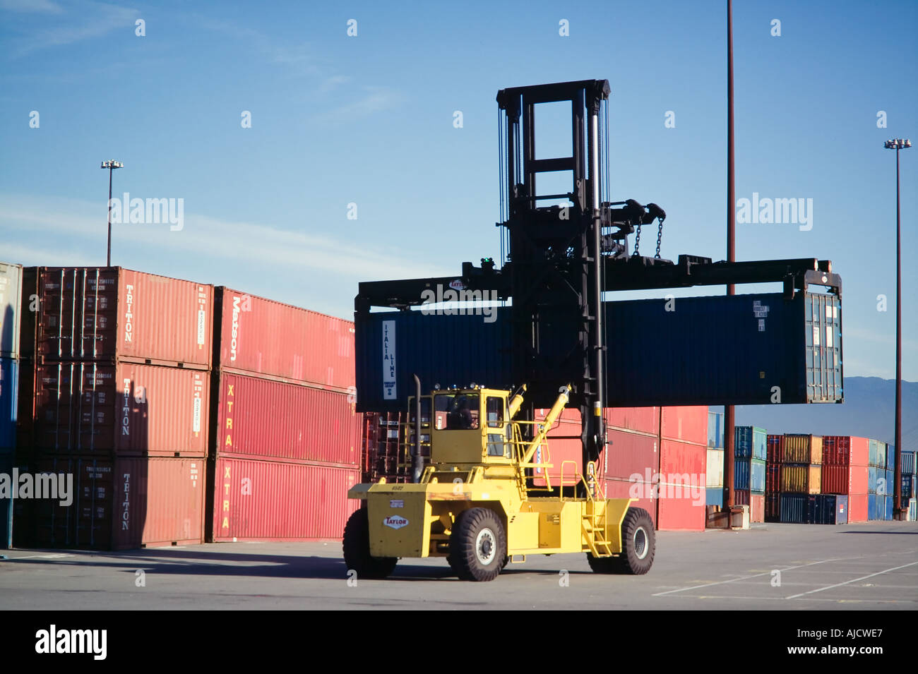Shipping containers moving containers with large mobile lifter Stock ...