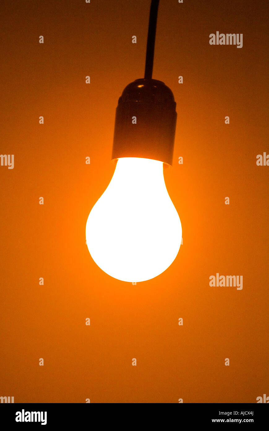 Lit tungsten lightbulbs handing from electrical cord Stock Photo - Alamy